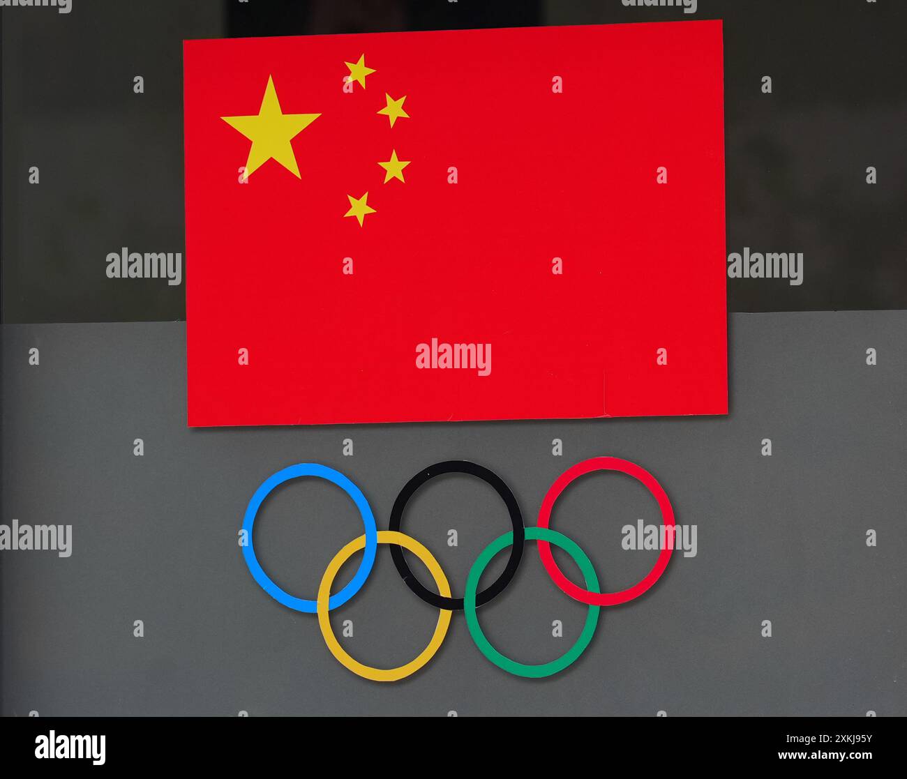 The flag of China and the Olympic Ring logo at the Olympic Village site ...