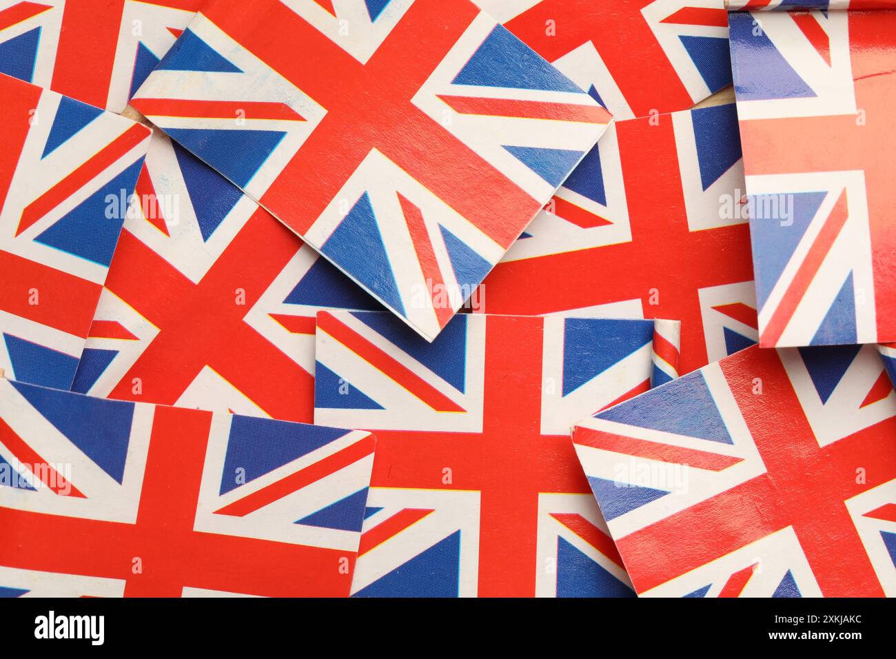Small paper flags of United Kingdom as background, top view Stock Photo ...