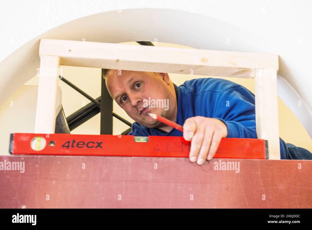 Carpenter hard at Work Carpenter working to close a circular gap in a ...