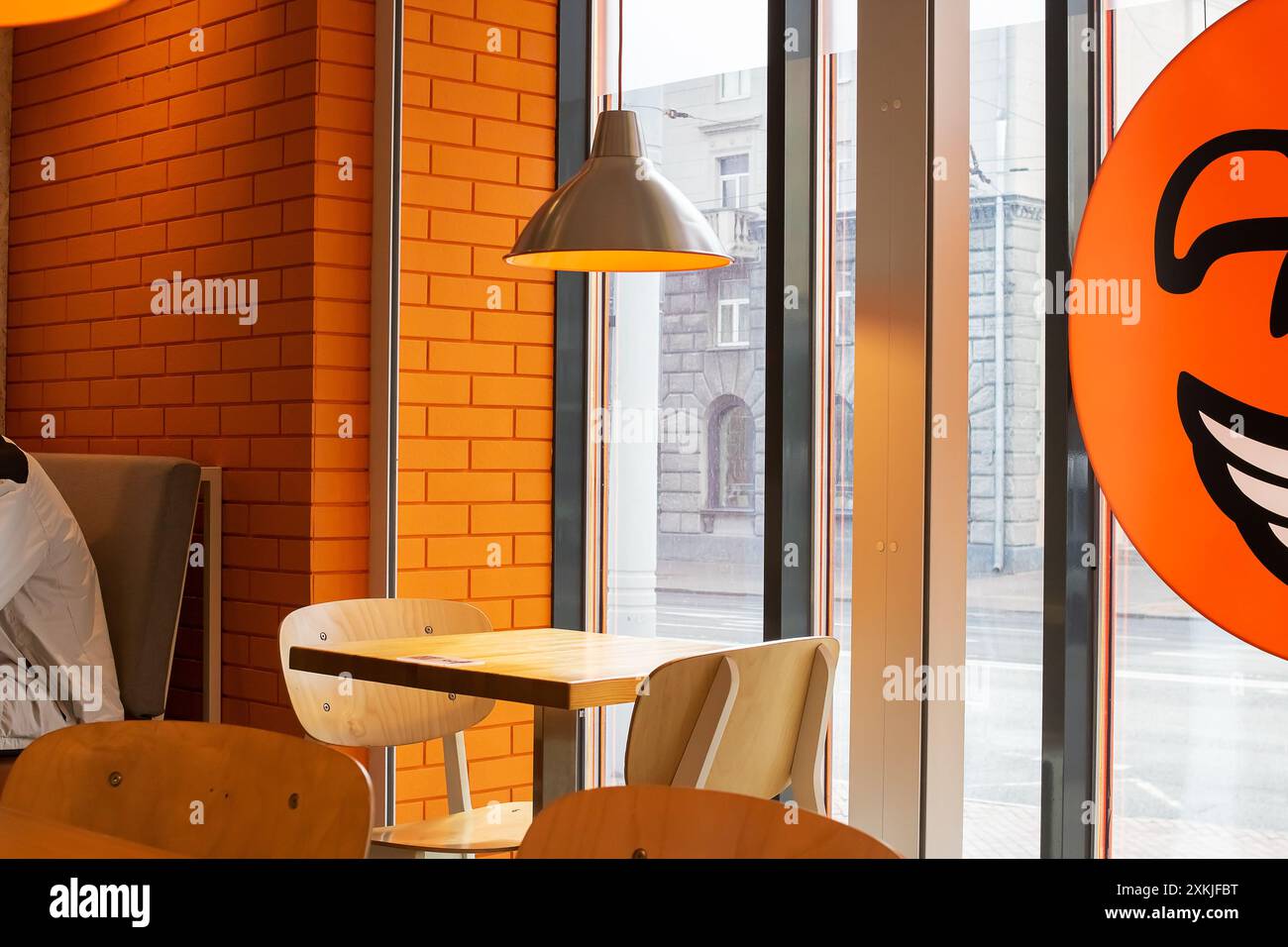 A cheerful restaurant with a smiley face decoration on the window ...