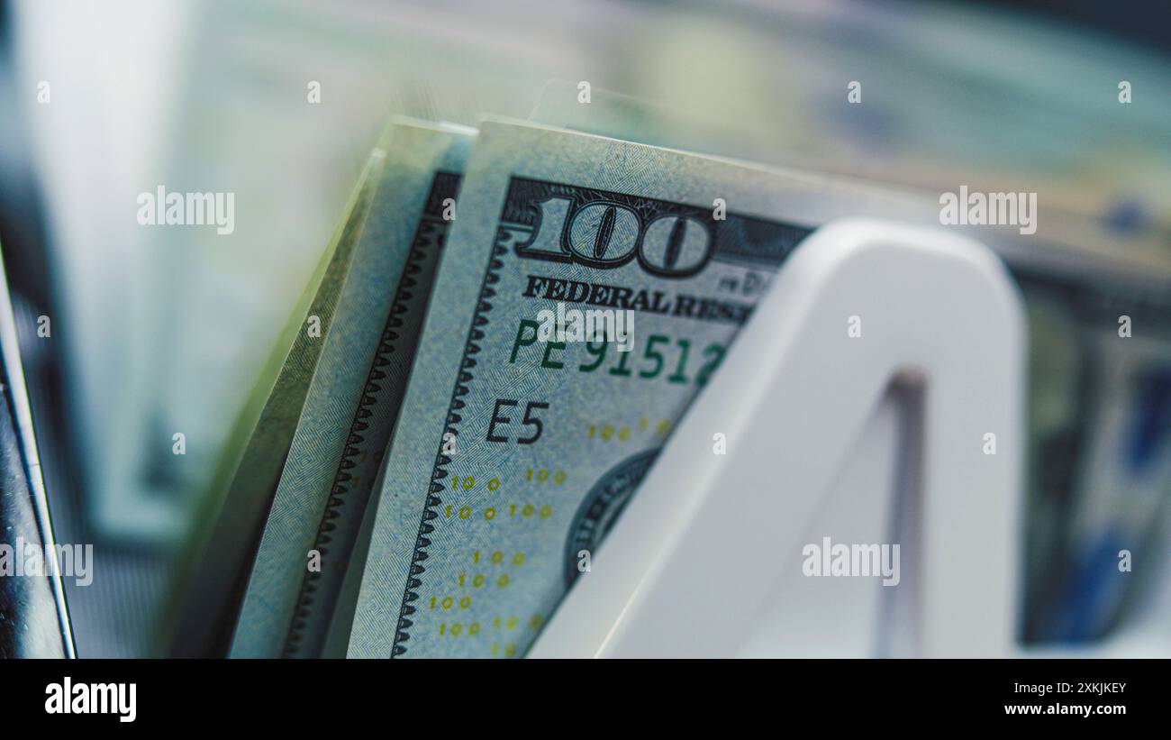 Close up of money counting machine counting hundred dollar banknotes ...