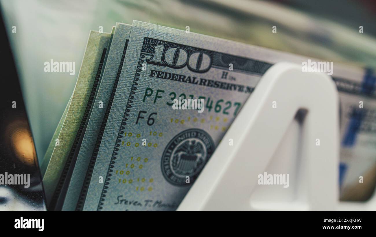 Money counting machine counts hundred dollar bank notes for currency ...