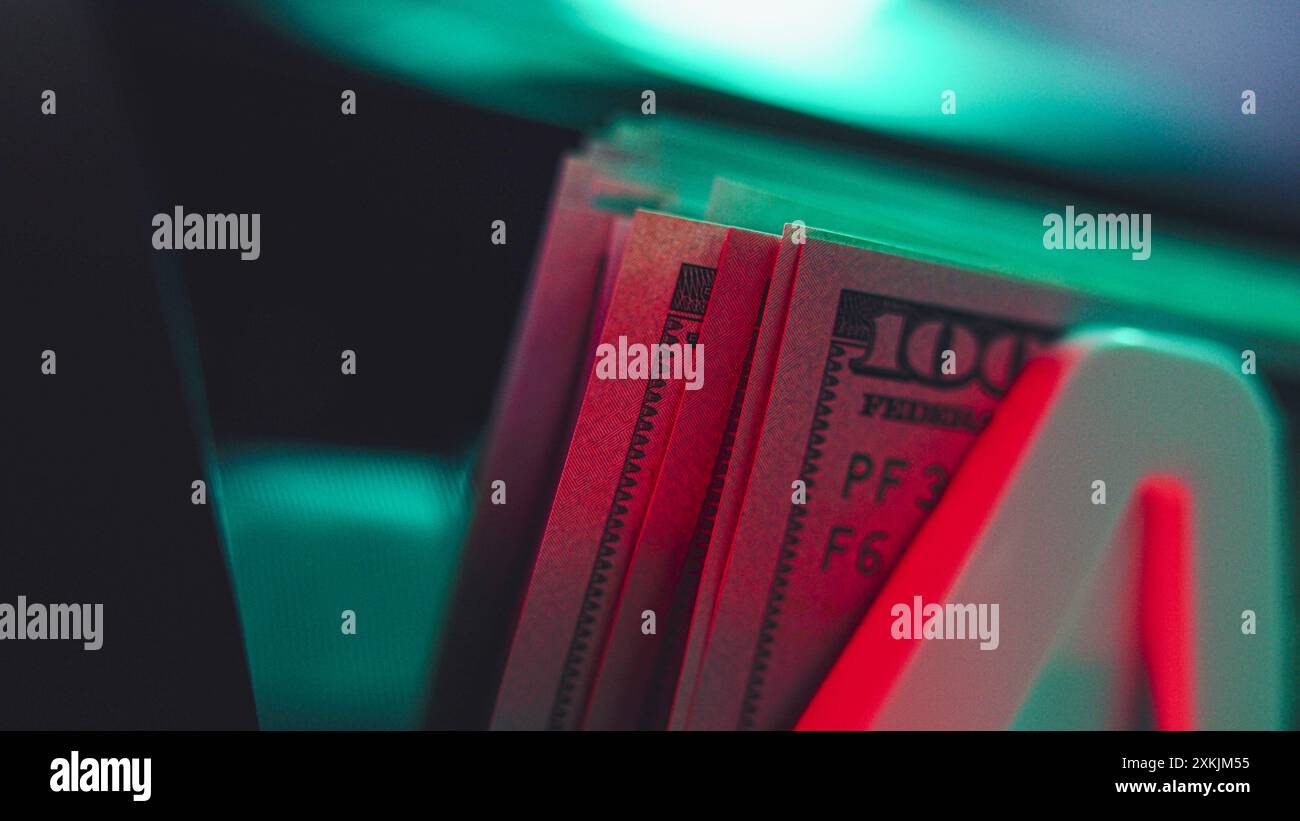 Close up of bill counter machine counting hundred dollar bills for ...