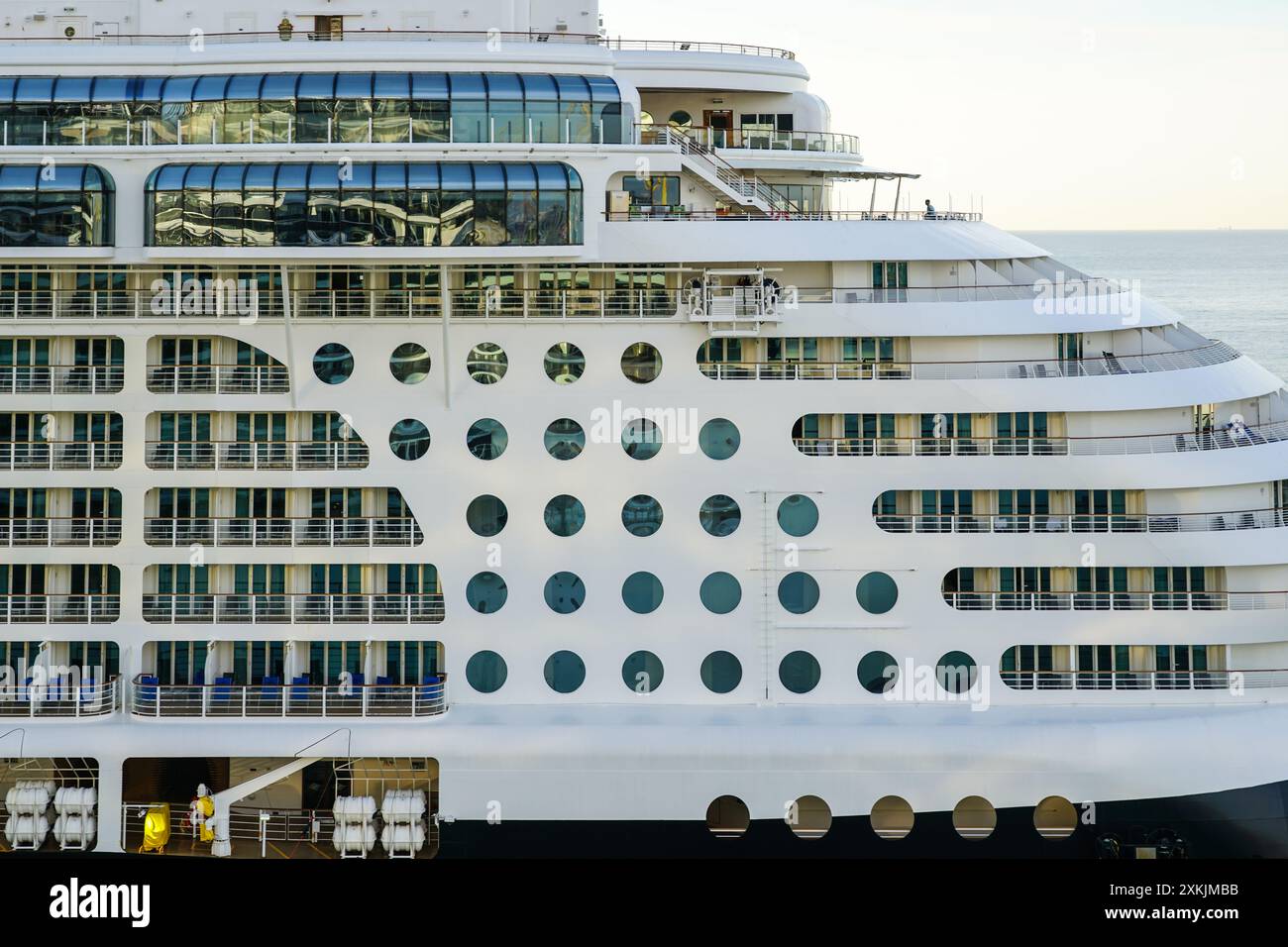 Large multi-deck cruise ship side view fragment with round portholes ...