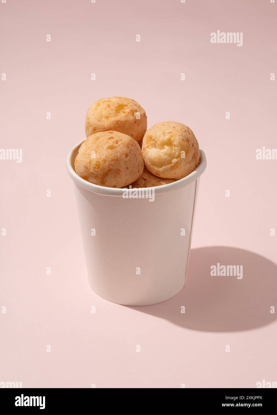 Brazilian cheese breads in paper bucket Stock Photo - Alamy