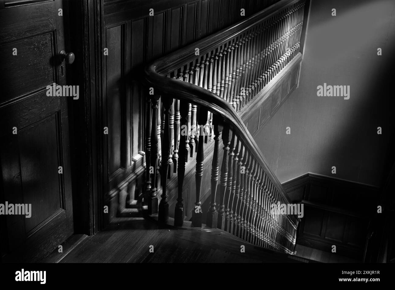 The dark passageway leading to a door at the top of stairs in this ...