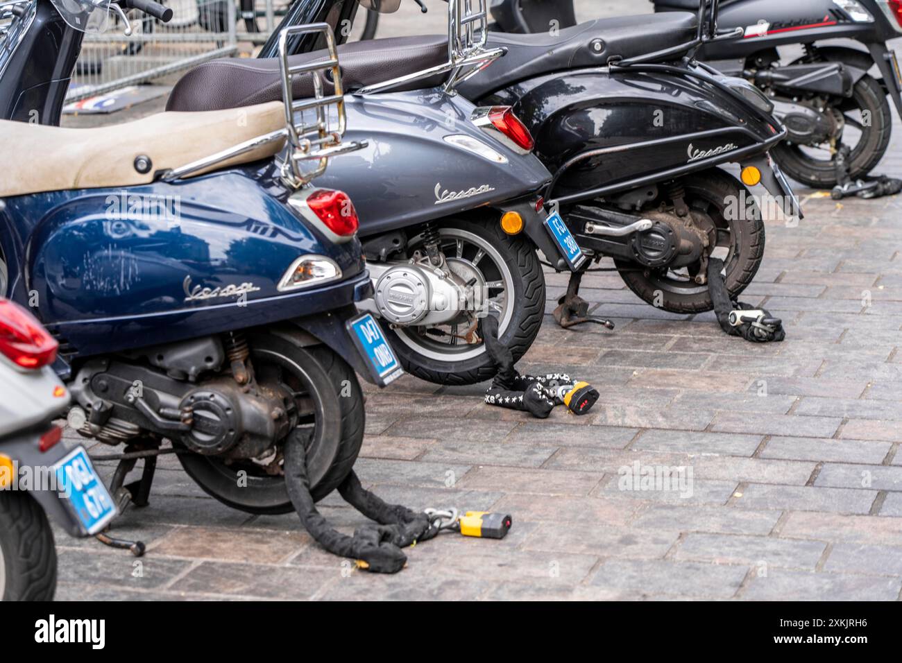 Motor scooter, locked with thick steel chains, parking lot in the city ...