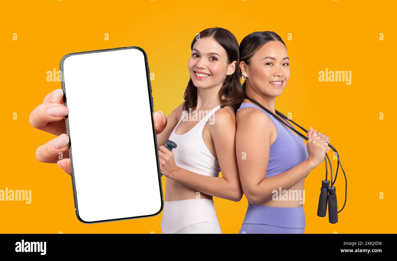 Two Women in Athletic Wear Holding Jump Rope and Smartphone Stock Photo ...