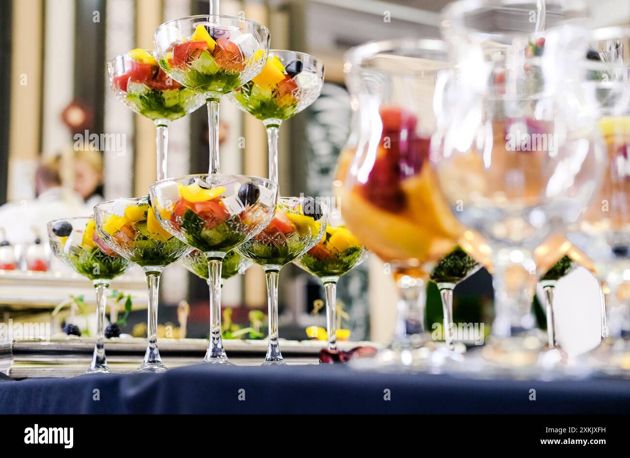Focus on glasses filled with vegetable salad, elegantly arranged on a ...
