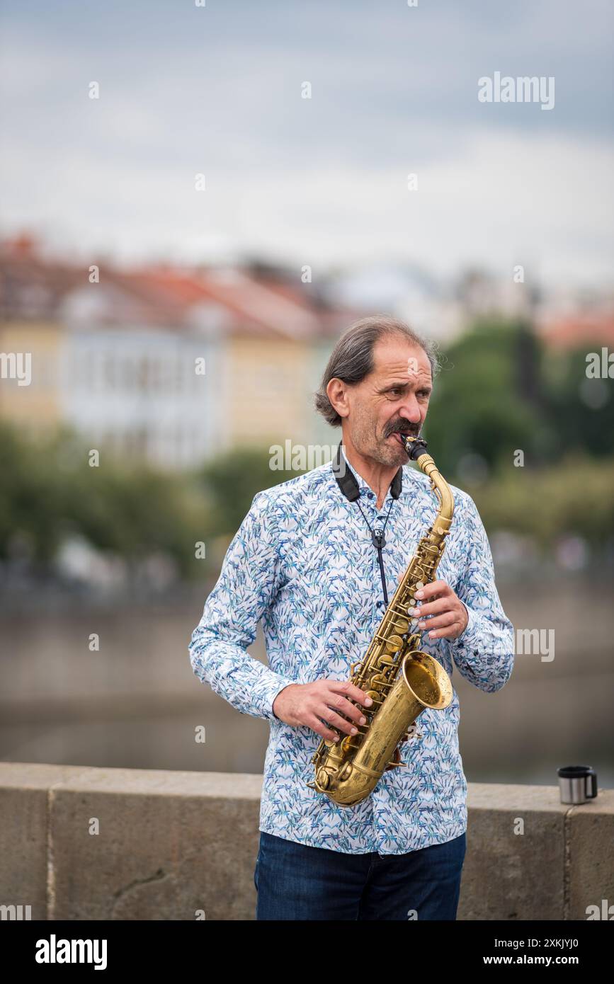 Street musician playing saxophone on the Charles bridge in Prague ...