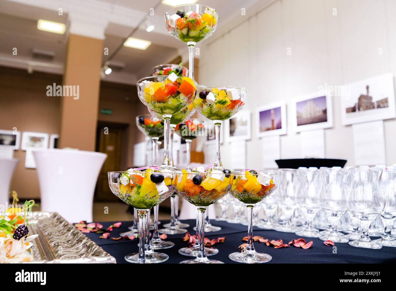 An original display of a pyramid of glass cups filled with vibrant ...