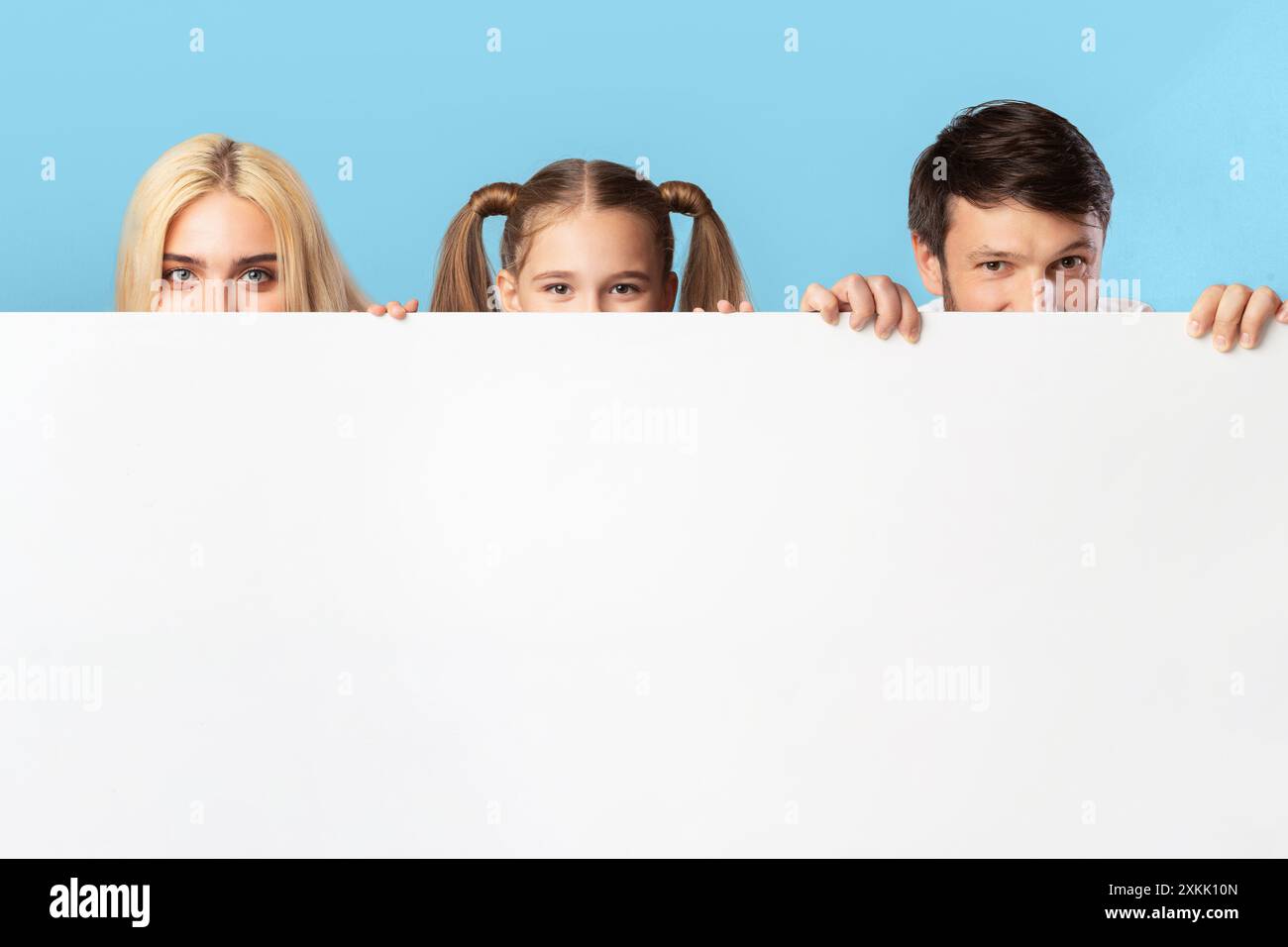 Happy Family Peeking Over White Sign Against Blue Background Stock ...