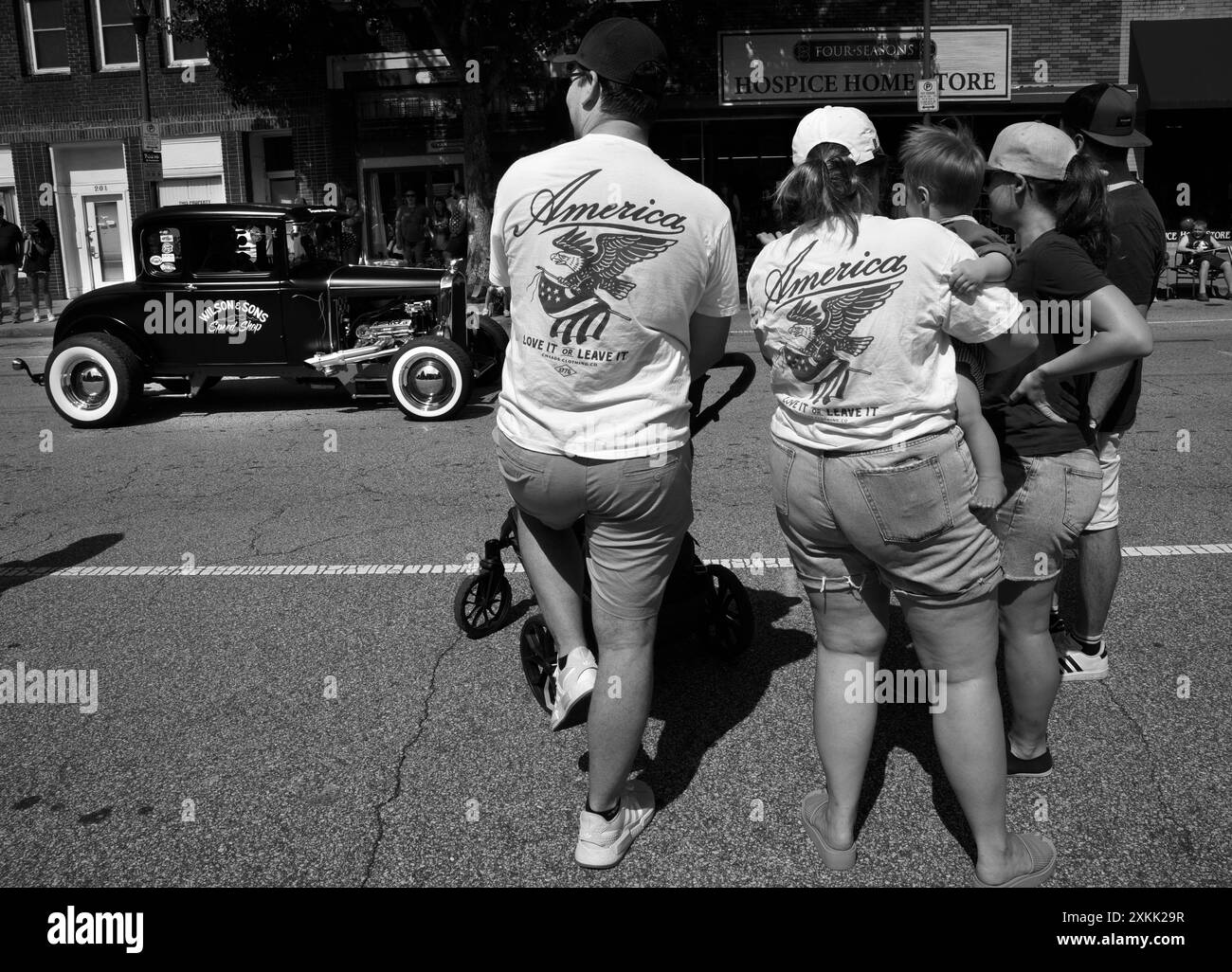 A couple wearing matching "America Love It or Leave It" T-shirts watch ...