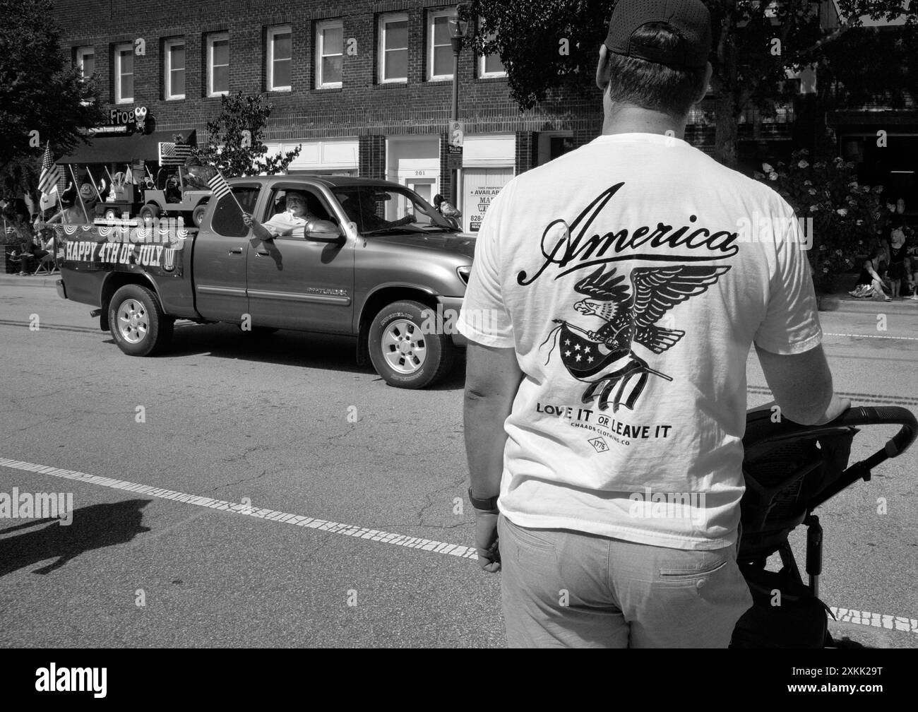 A couple wearing matching "America Love It or Leave It" T-shirts watch ...