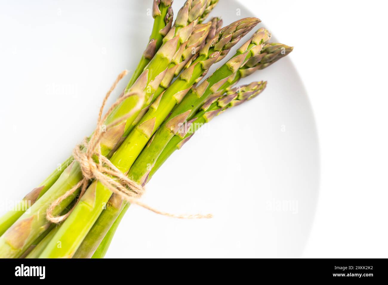 A pile of raw garden asparagus with isolated shade. Fresh green spring ...
