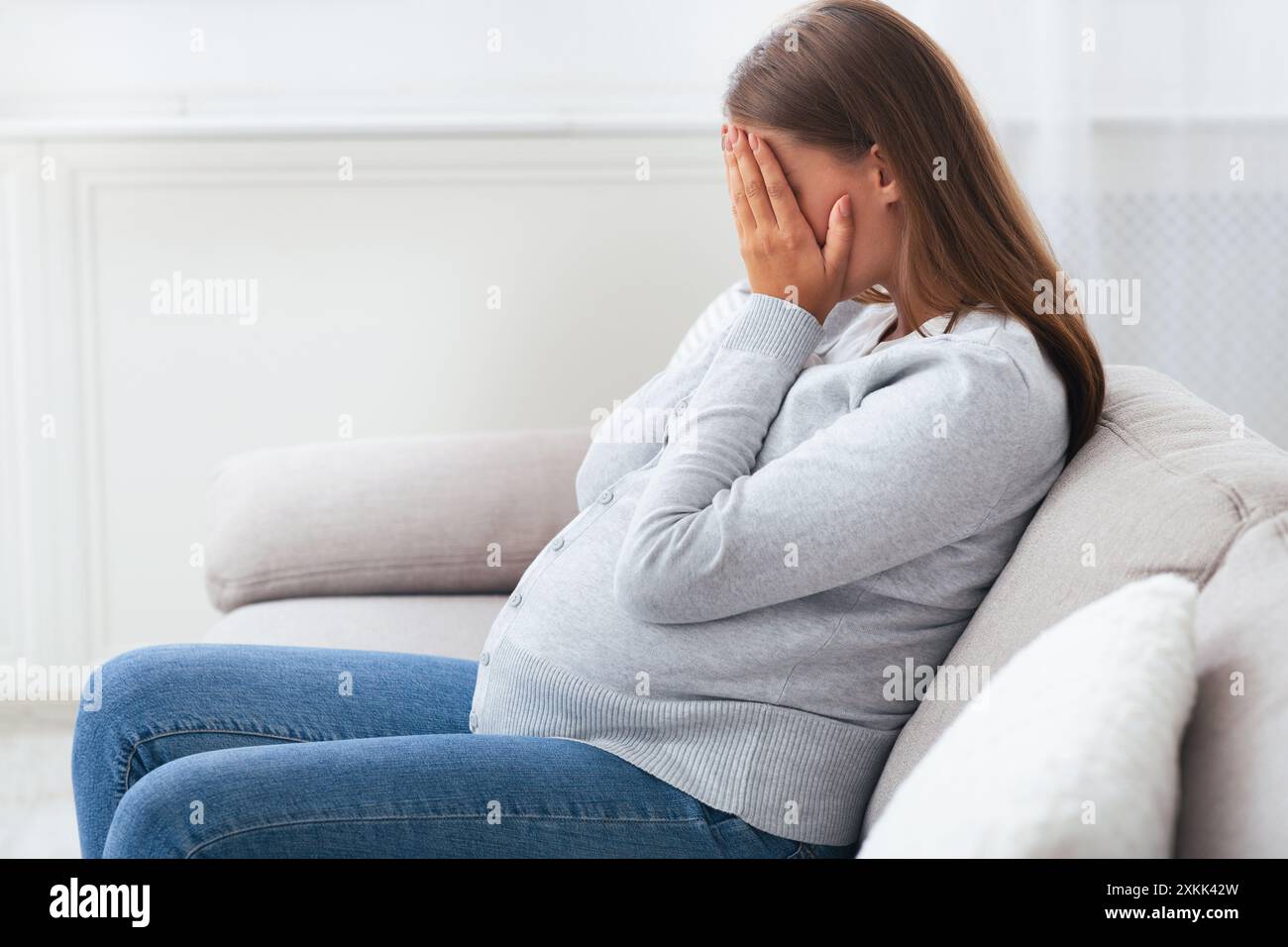 Pregnant Lady Crying Covering Face With Hands Sitting At Home Stock ...