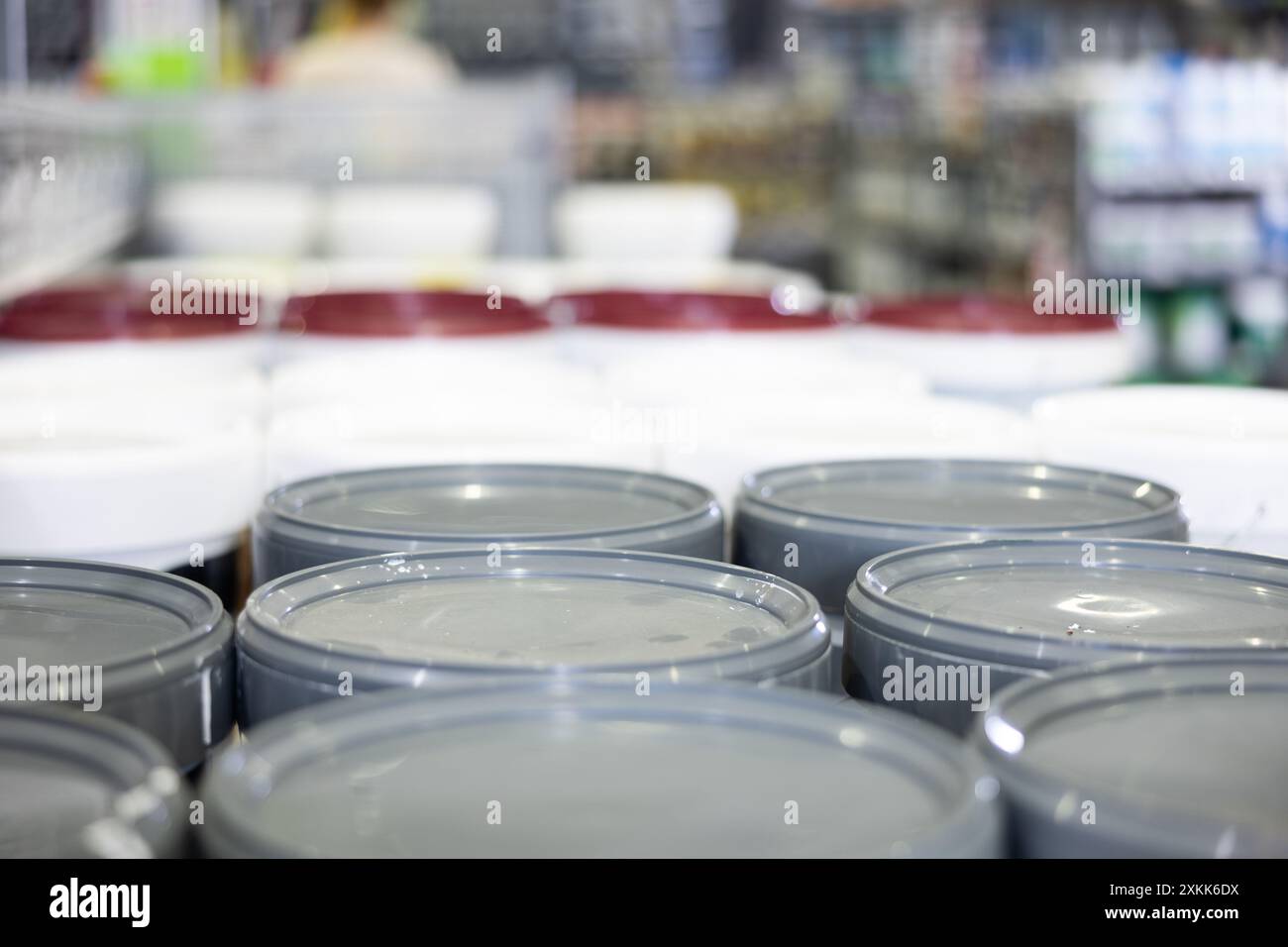 Lids on plastic paint buckets displayed in construction hypermarket ...