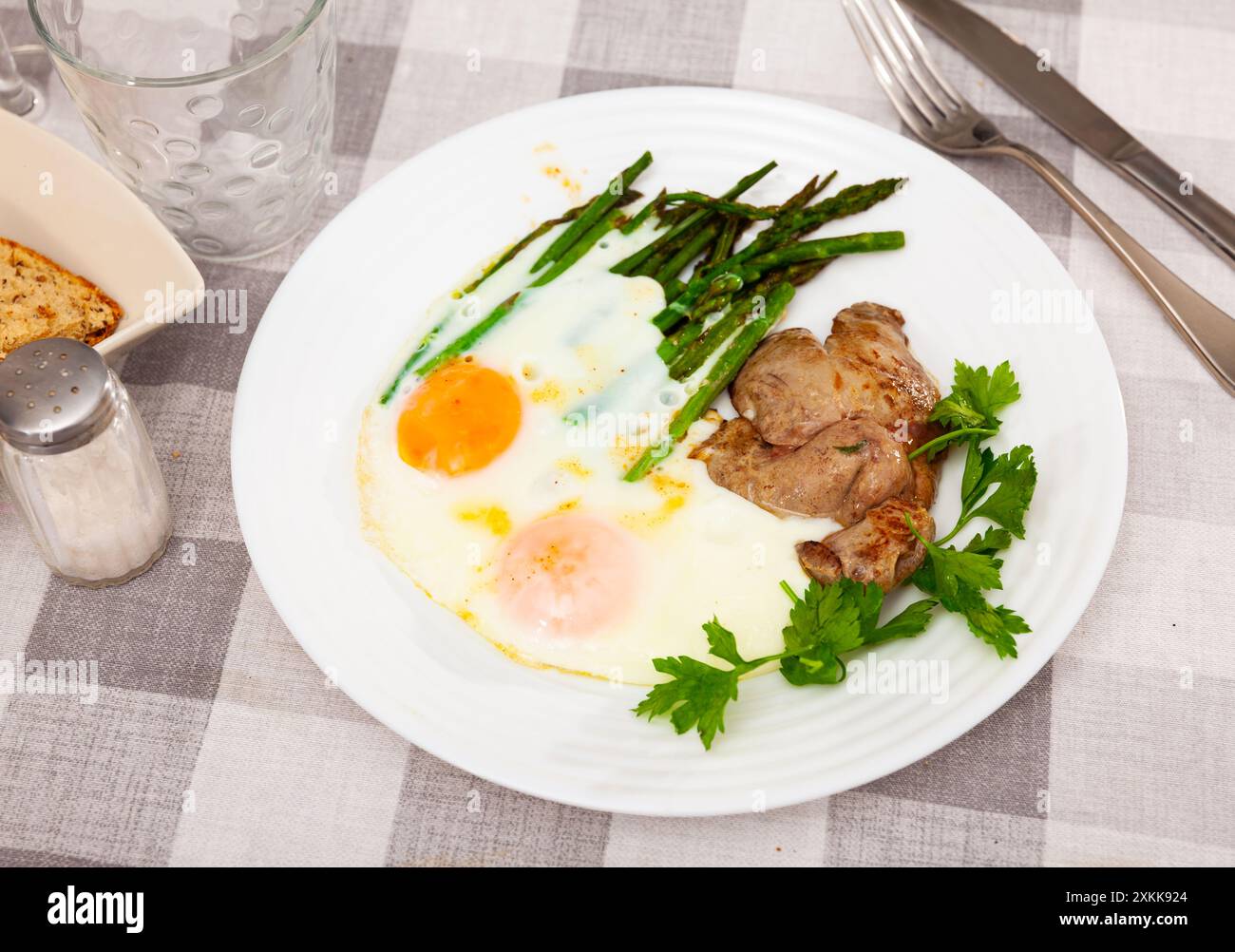 Roasted rabbit liver with fried eggs and asparagus Stock Photo - Alamy