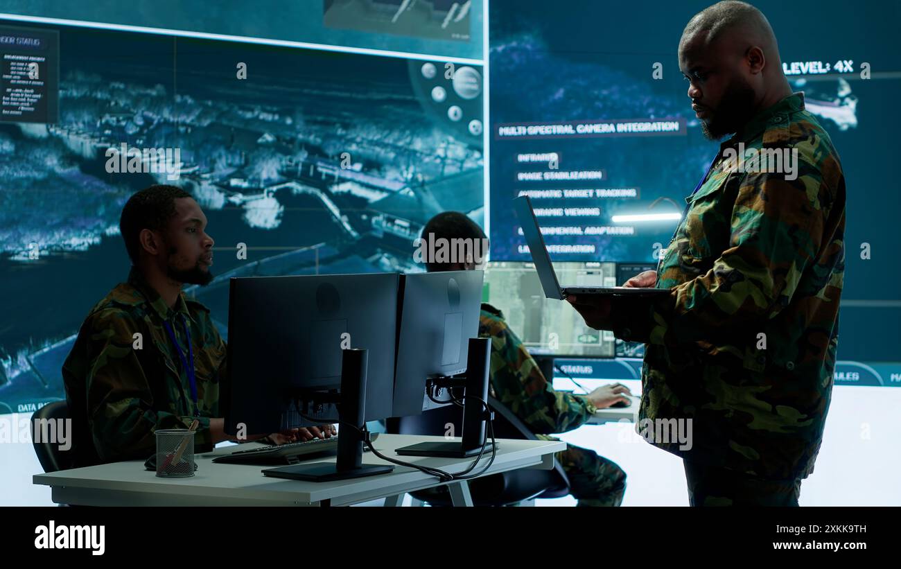 Cybersecurity team operates in an advanced military command center ...