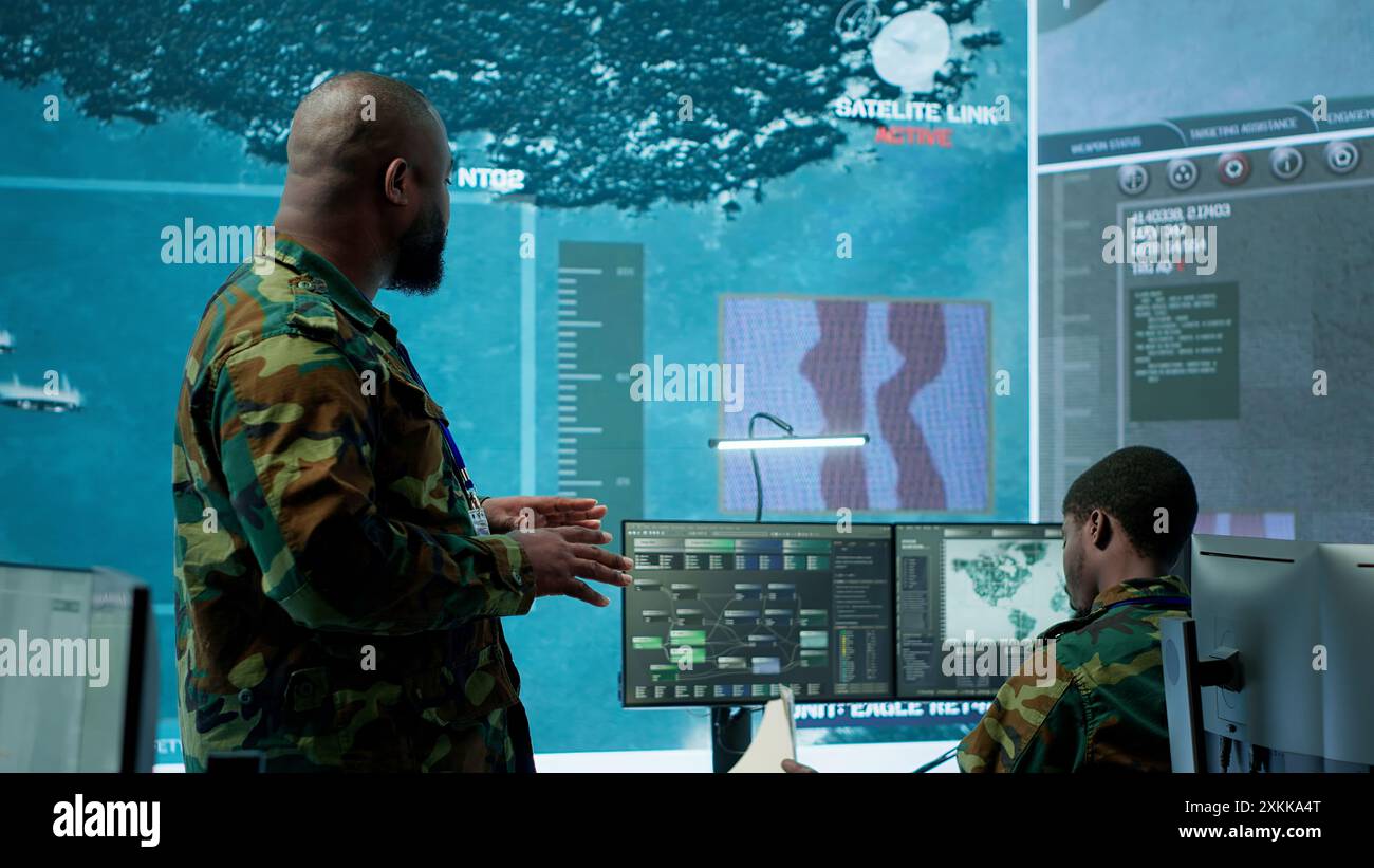 Military team operating in a high tech command post control tower, focusing on surveillance ...