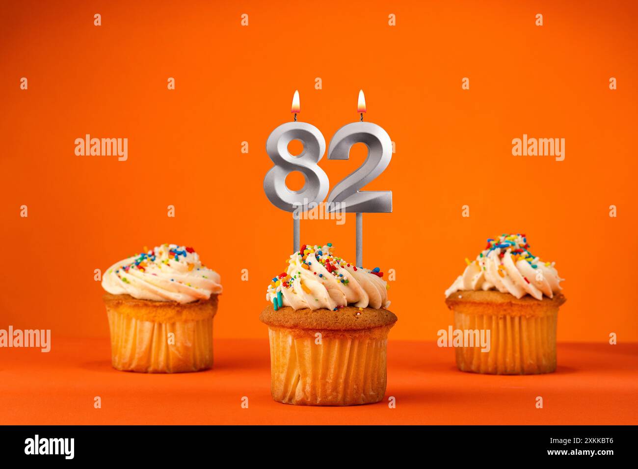 Birthday celebration in orange color - Candle number 82 Stock Photo - Alamy