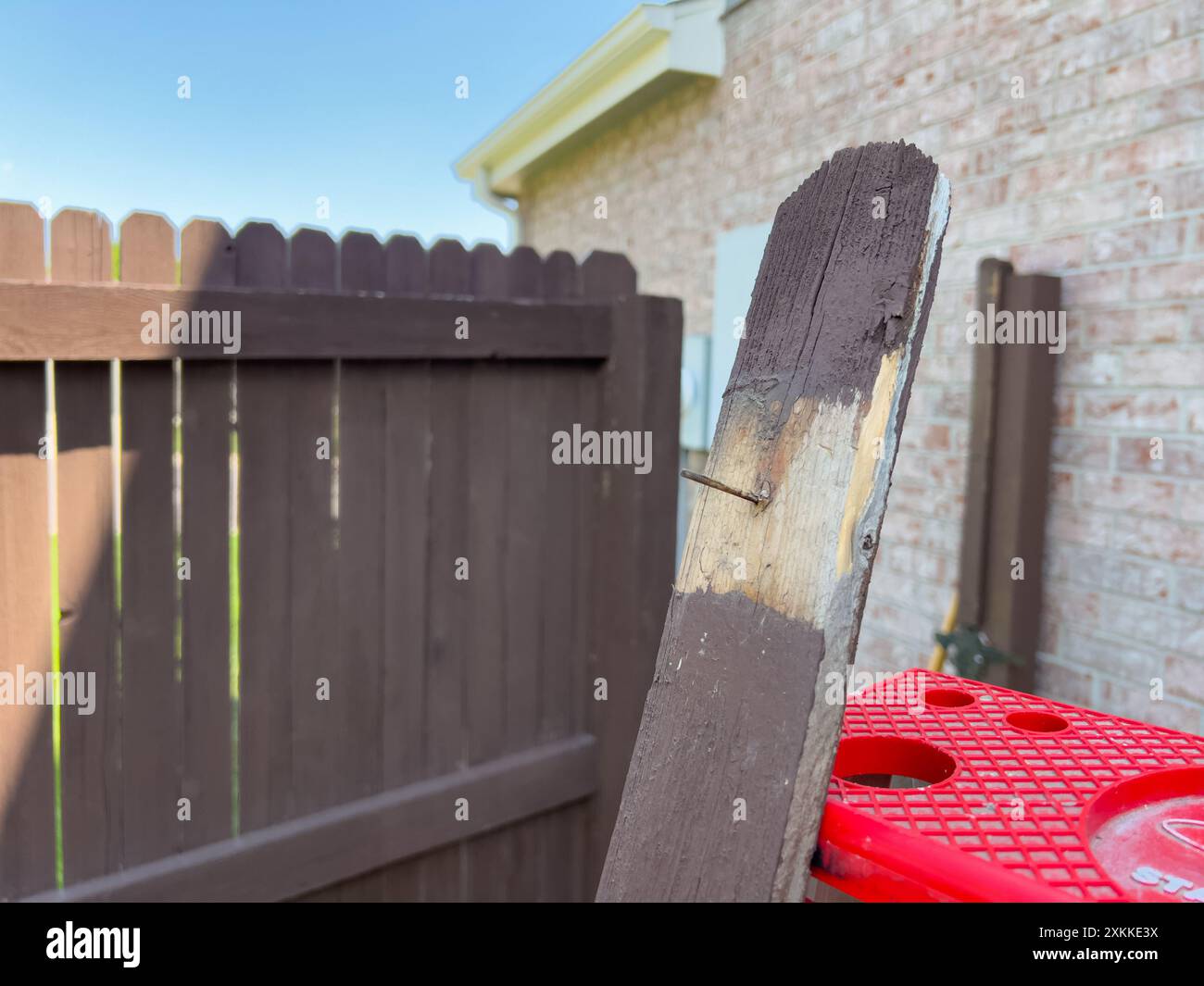 Repairing a Fence Post with Tools and Brick Pavers Stock Photo - Alamy