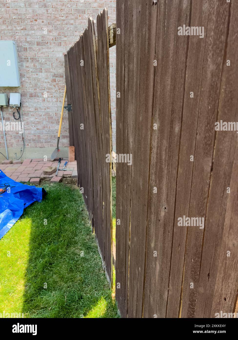 Repairing a Fence Post with Tools and Brick Pavers Stock Photo - Alamy