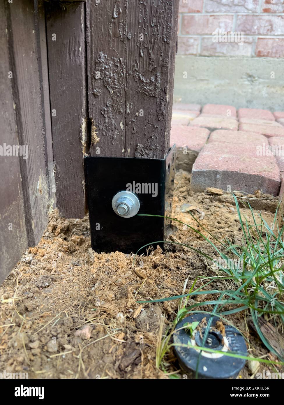 Repairing a Fence Post with Tools and Brick Pavers Stock Photo - Alamy