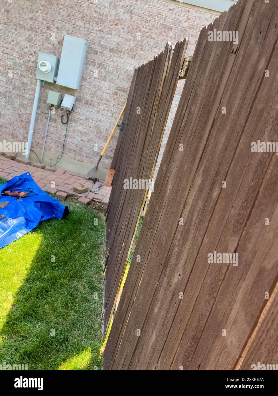 Repairing a Fence Post with Tools and Brick Pavers Stock Photo - Alamy