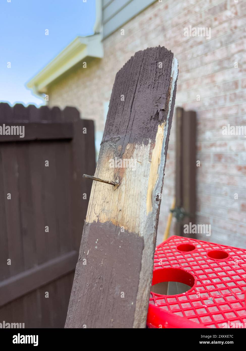 Repairing a Fence Post with Tools and Brick Pavers Stock Photo - Alamy