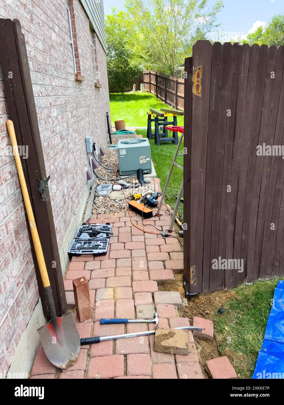 Repairing a Fence Post with Tools and Brick Pavers Stock Photo - Alamy