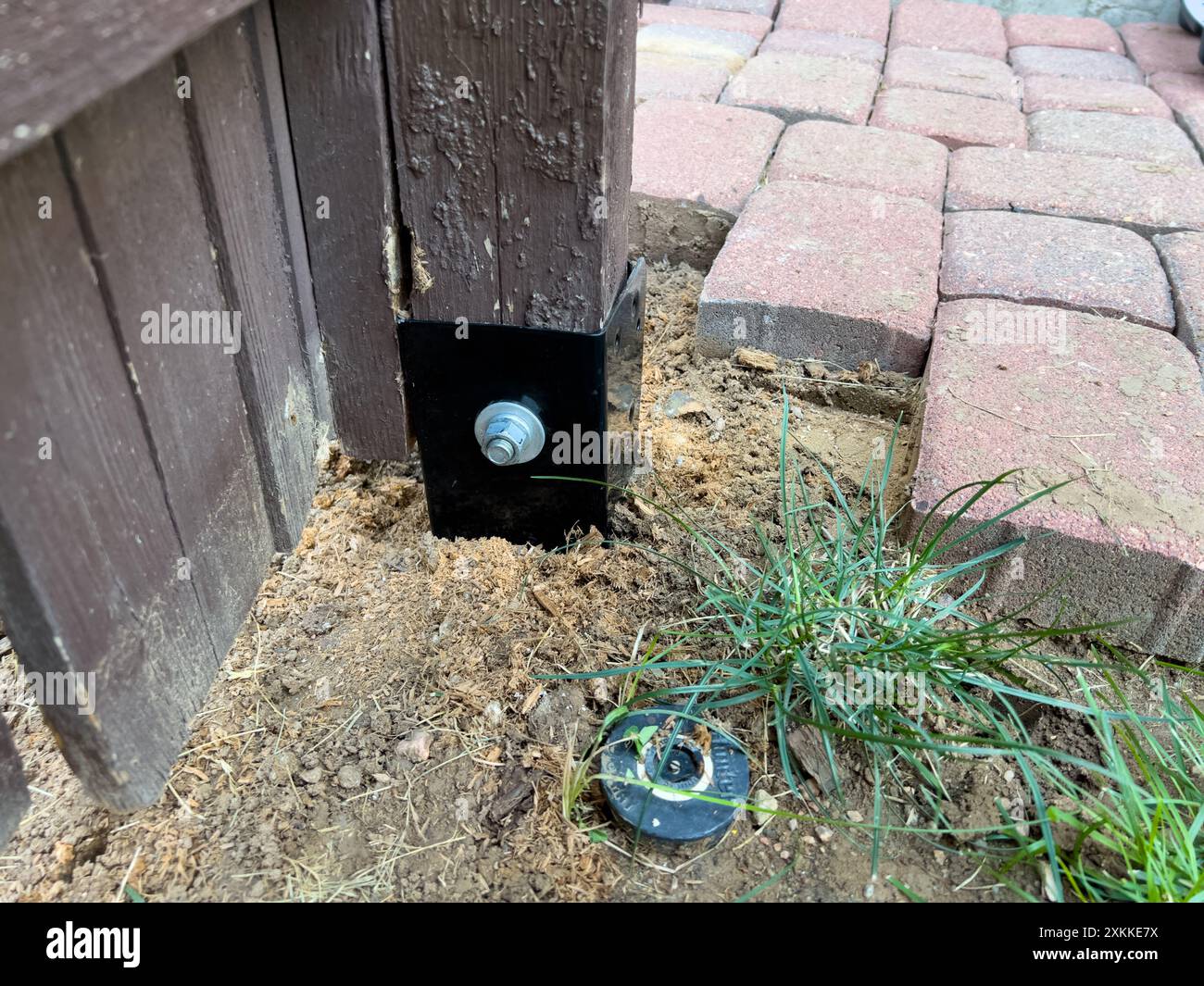 Repairing a Fence Post with Tools and Brick Pavers Stock Photo - Alamy