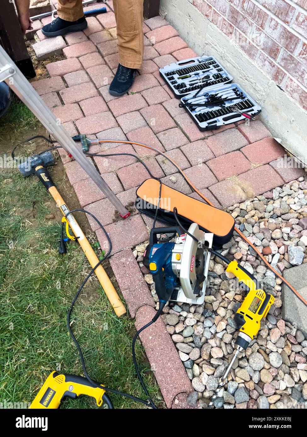 Repairing a Fence Post with Tools and Brick Pavers Stock Photo - Alamy