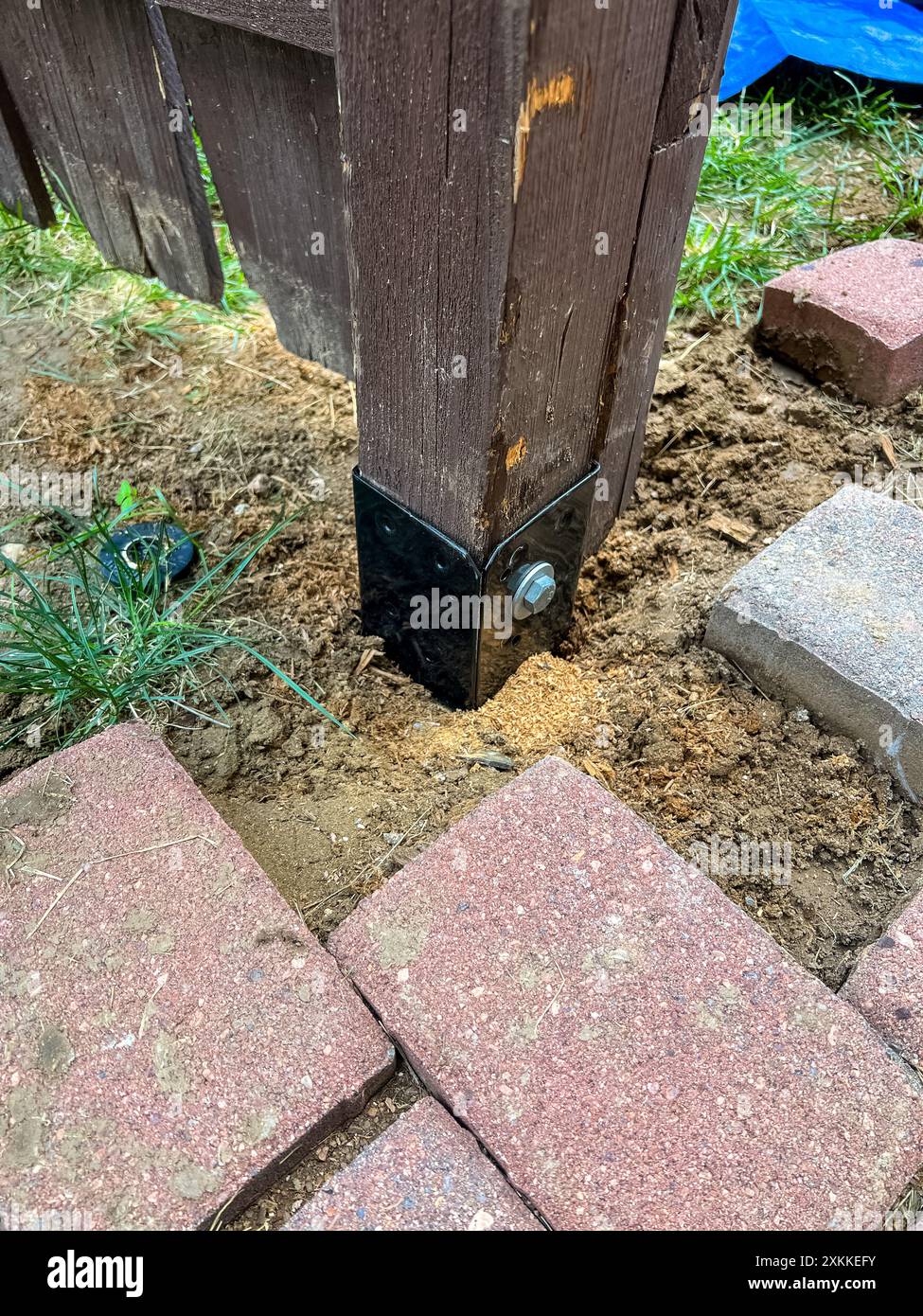 Repairing a Fence Post with Tools and Brick Pavers Stock Photo - Alamy