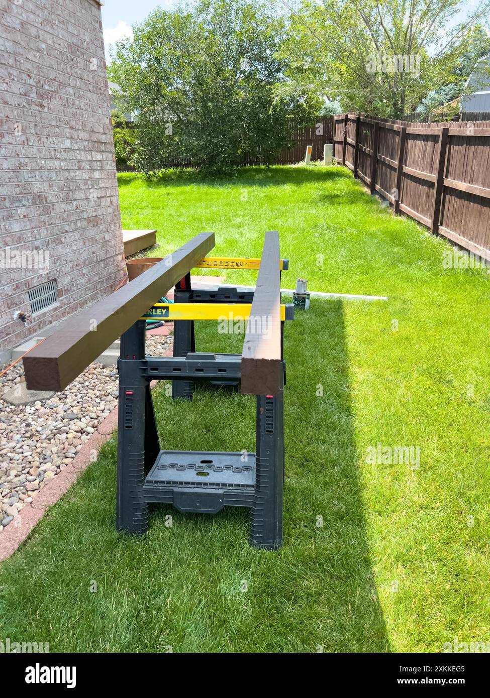 Repairing a Fence Post with Tools and Brick Pavers Stock Photo - Alamy
