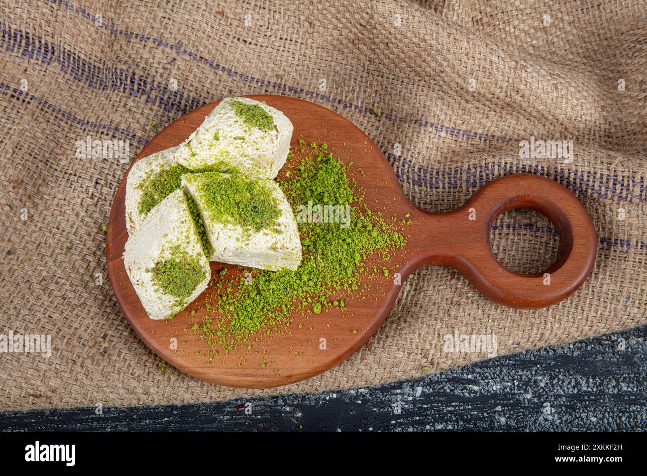 Pistachio halva (Halvah). Halva with pistachios on a rustic wooden ...