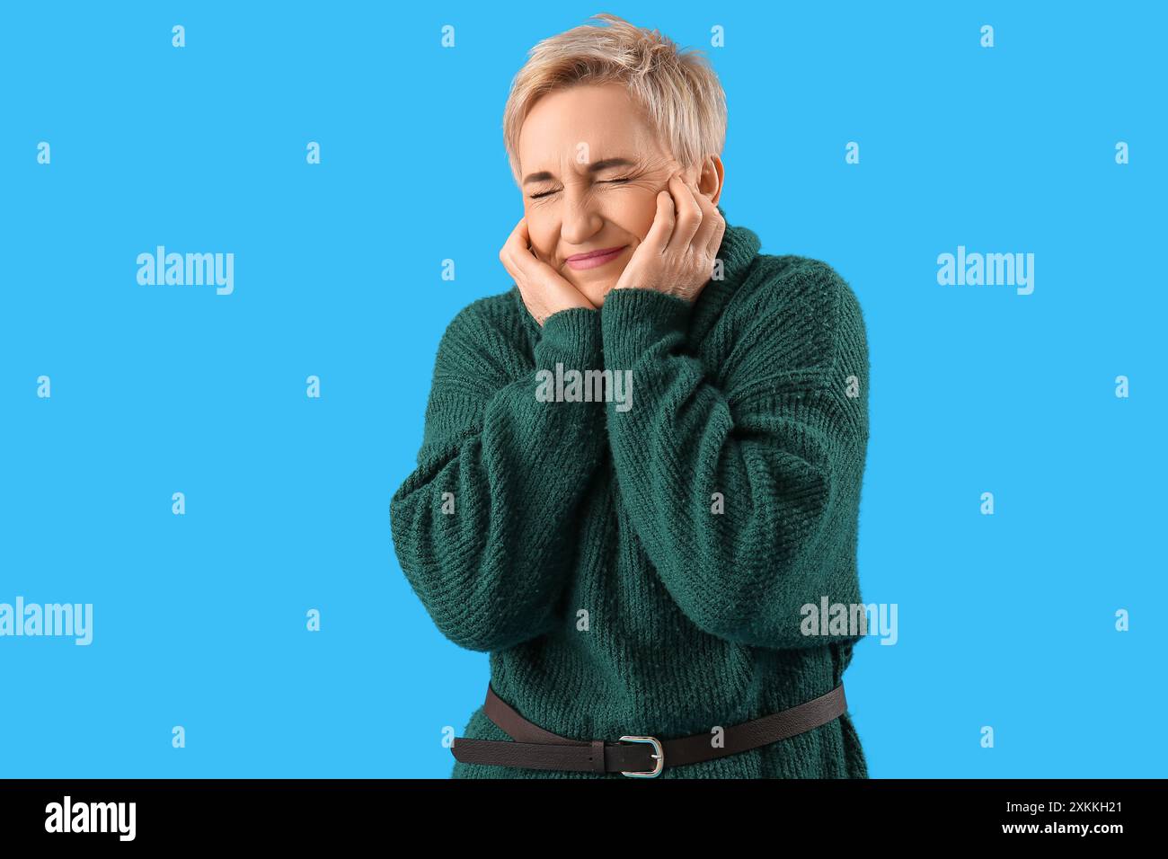 Scared mature woman on light blue background Stock Photo - Alamy