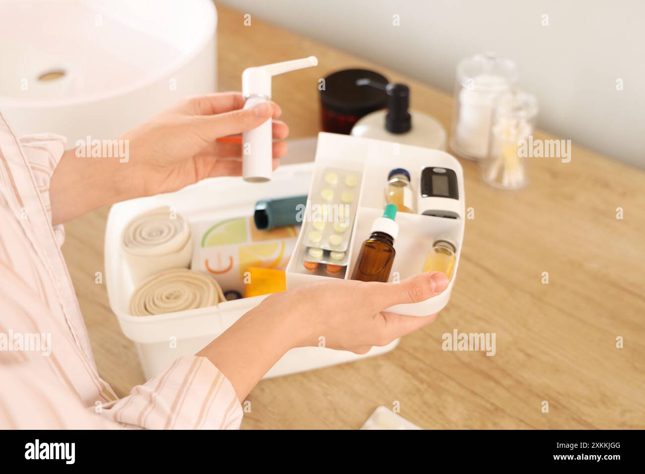 Woman with first aid kit and medications in bathroom, closeup Stock ...