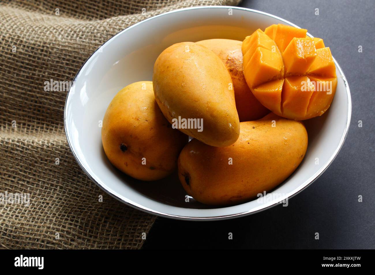 Bowl of mangoes on dark background Stock Photo - Alamy