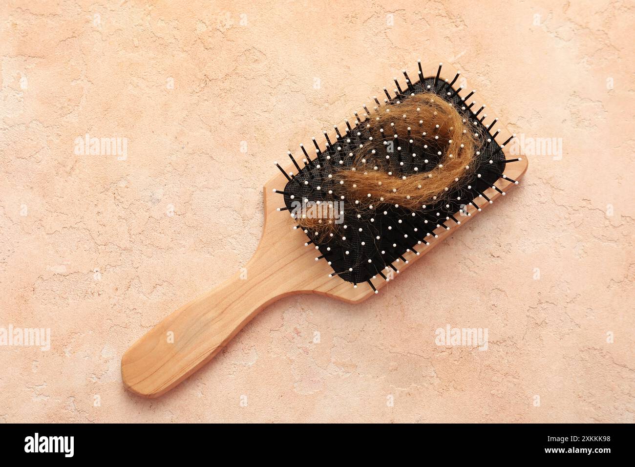 Brush and question mark made of hair strand on beige background. Hair ...