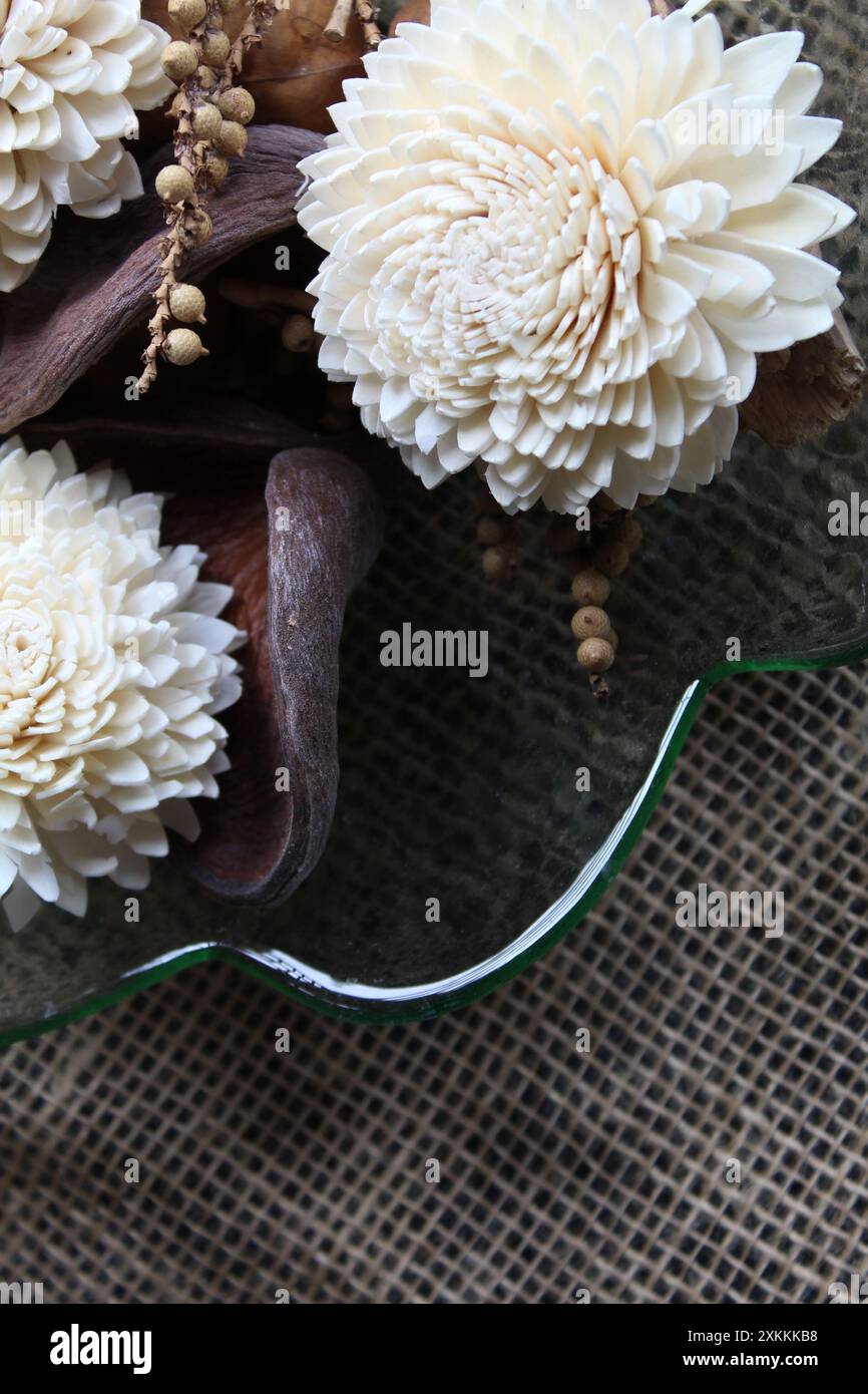 Decorative dried flowers, seed pods, and branches in glass bowl Stock ...