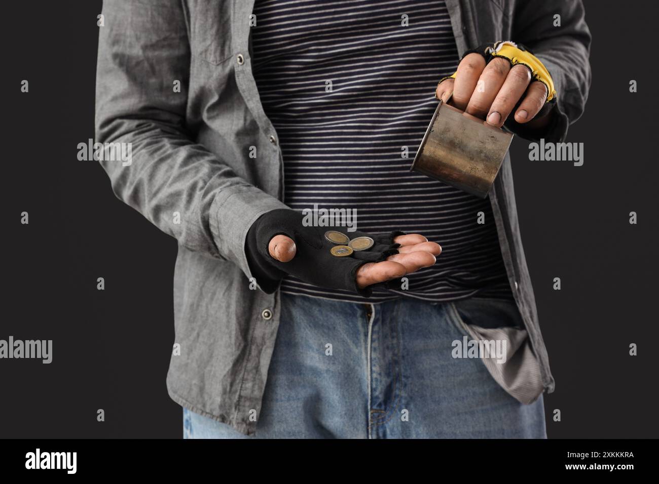 Mature homeless man with cup and coins on dark background, closeup ...