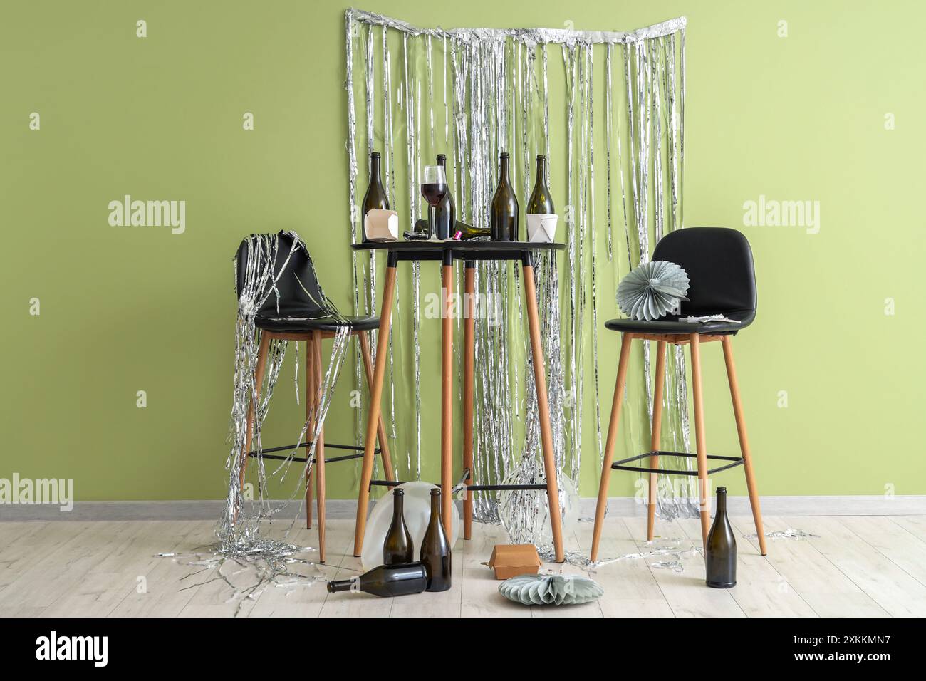 Interior of messy room after Birthday celebration with table, stools ...