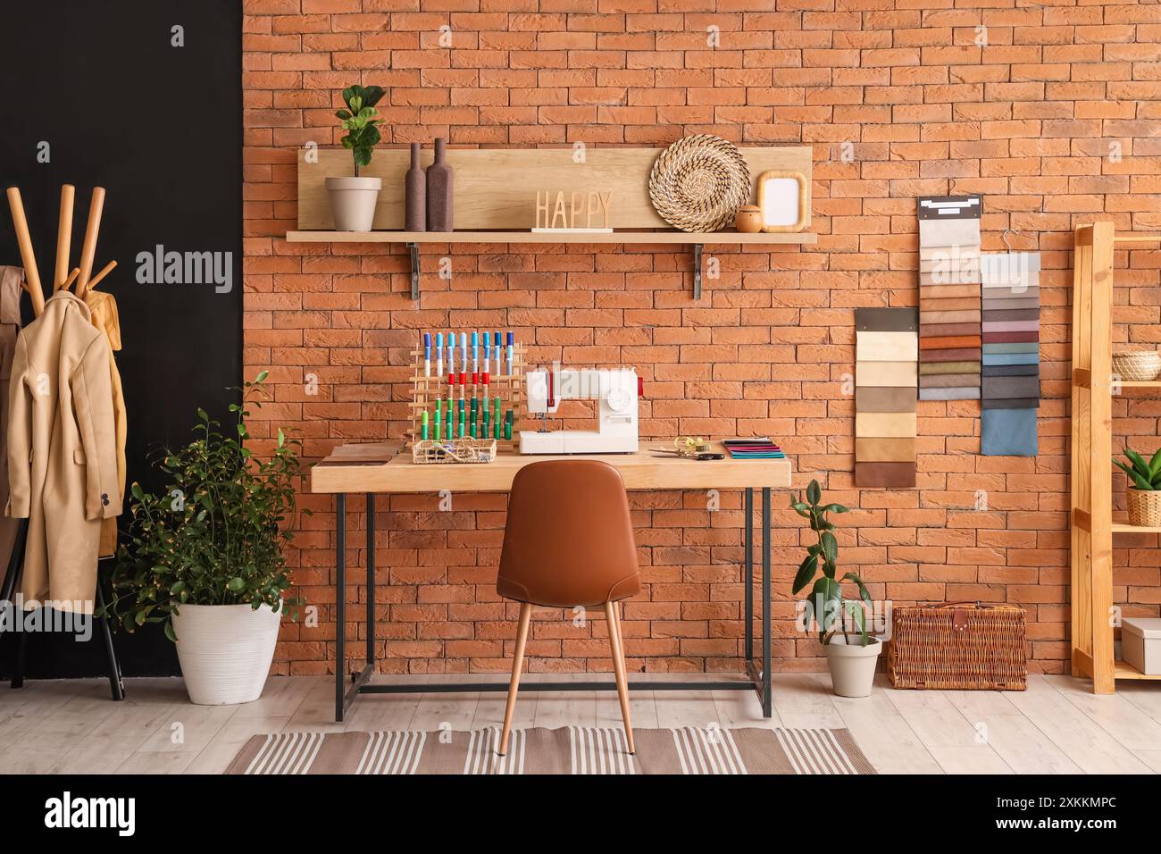 Interior of atelier with tailor's workplace, shelf and clothes rack ...