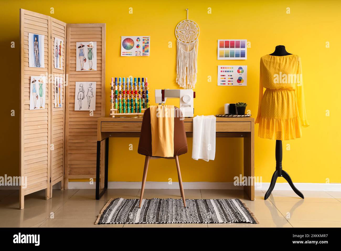 Interior of atelier with tailor's workplace, mannequin and folding ...