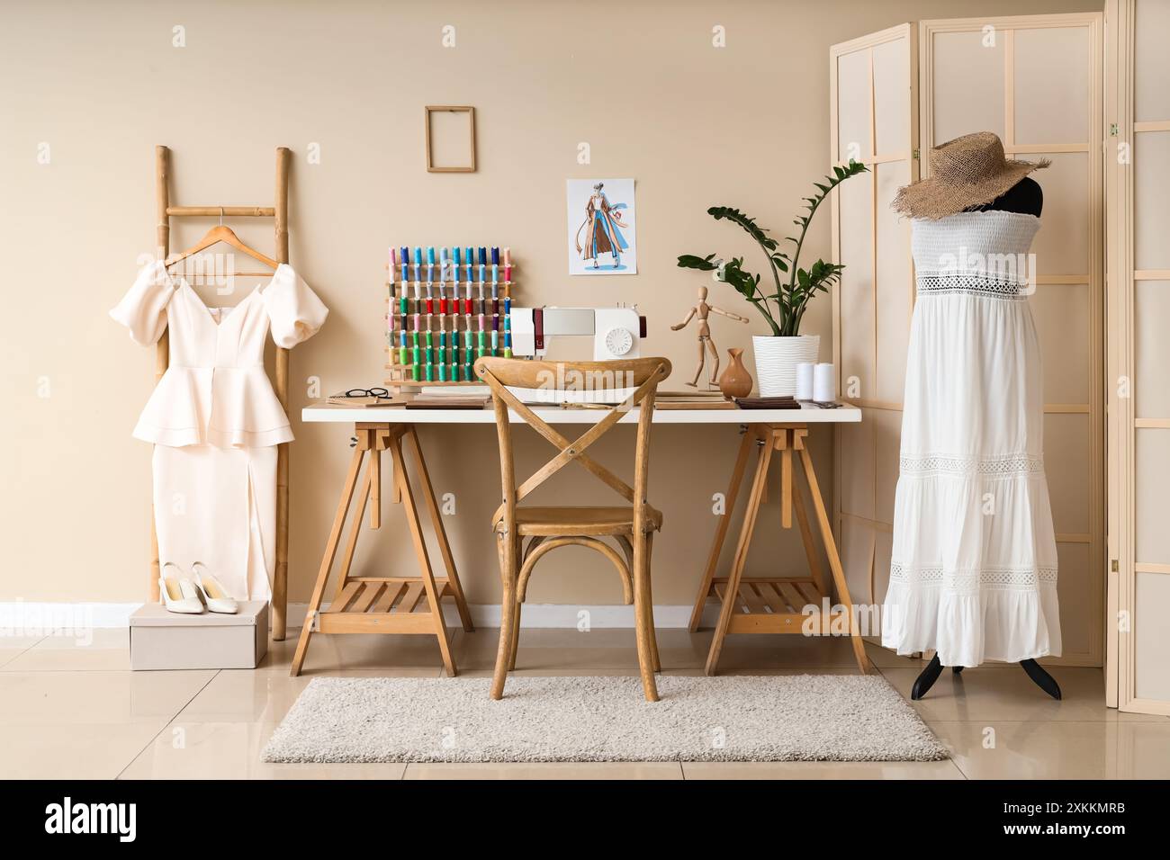 Interior of atelier with tailor's workplace, mannequin and folding ...