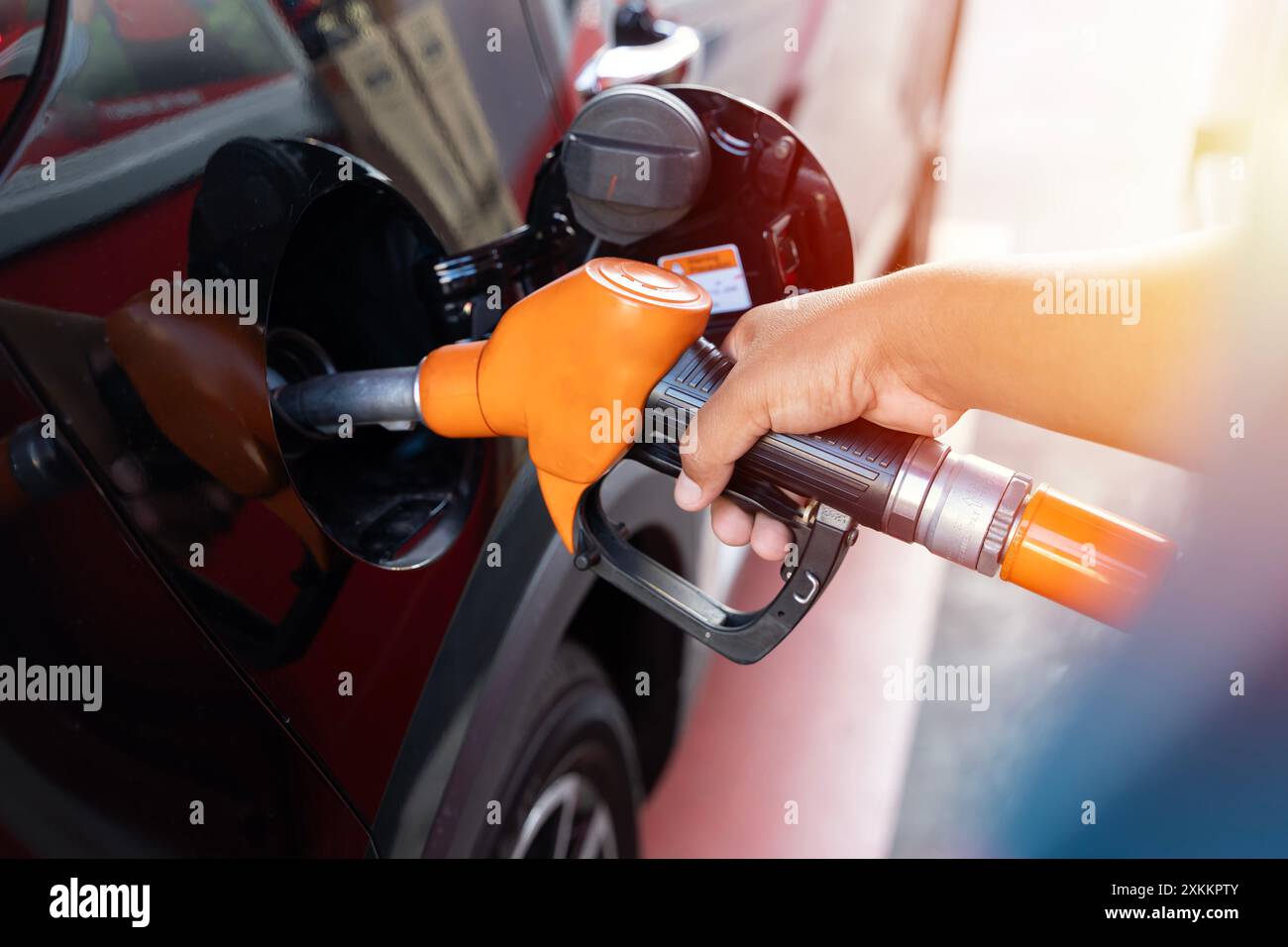 Man driver hand refilling and pumping gasoline oil the car with fuel at ...