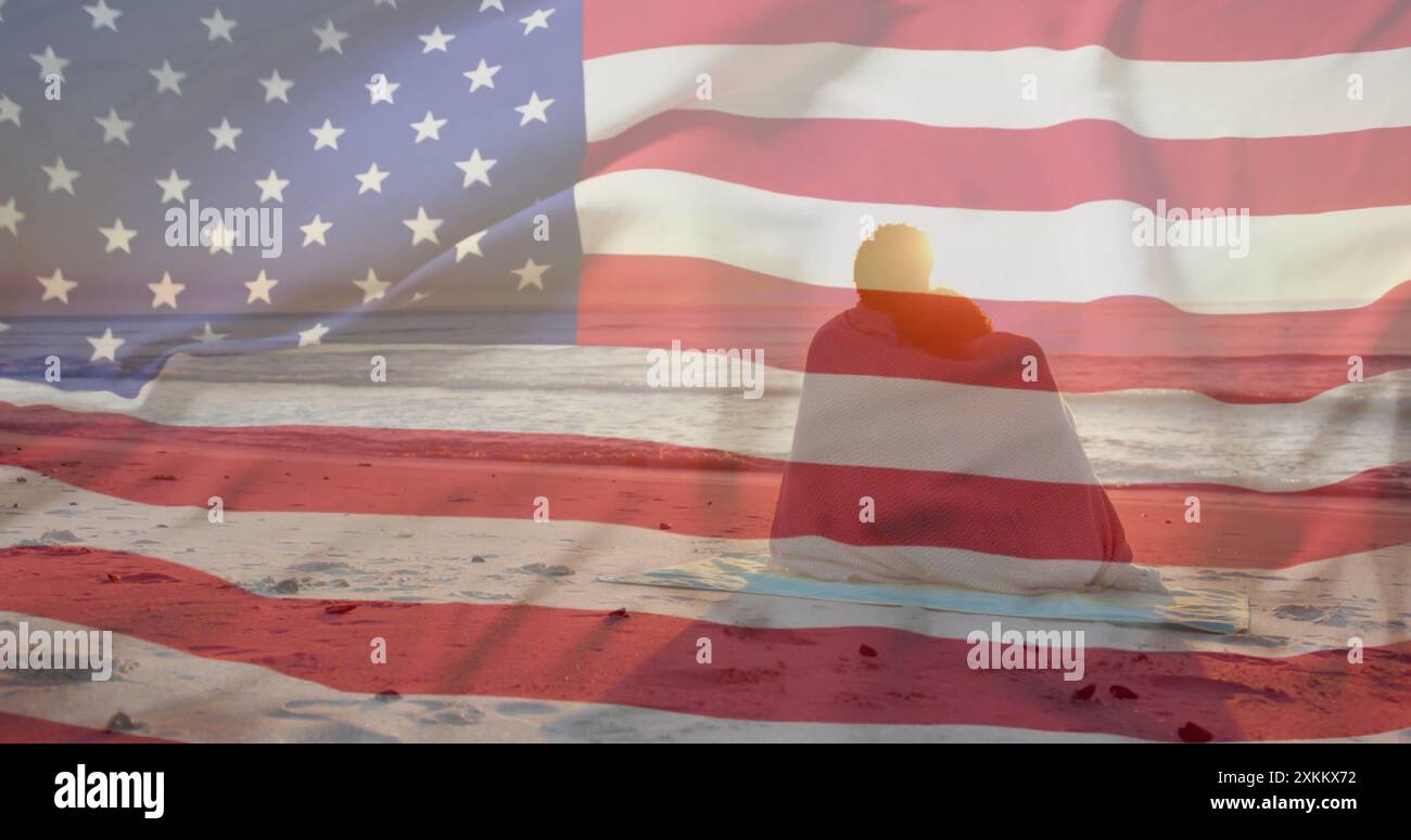 Image of american flag over happy diverse couple wrapped in rug ...