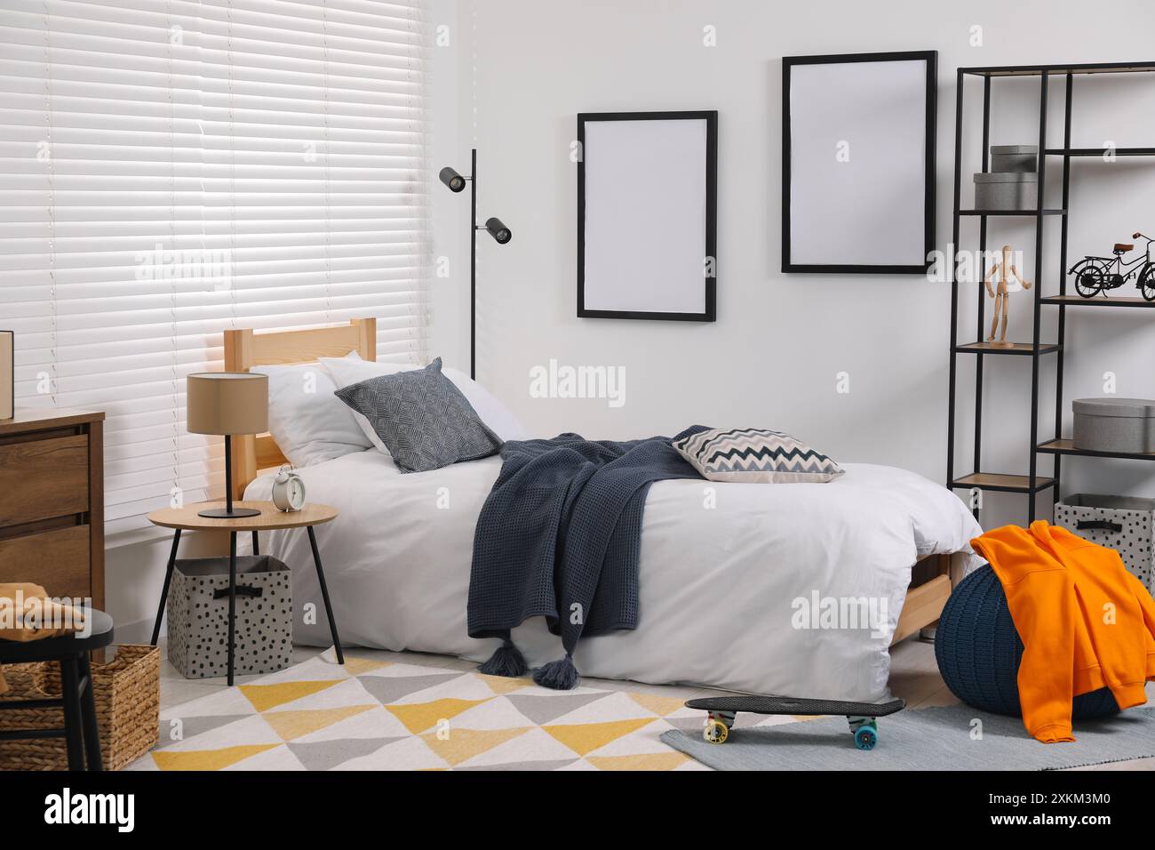 Teen's room interior with modern furniture and empty frames on wall ...