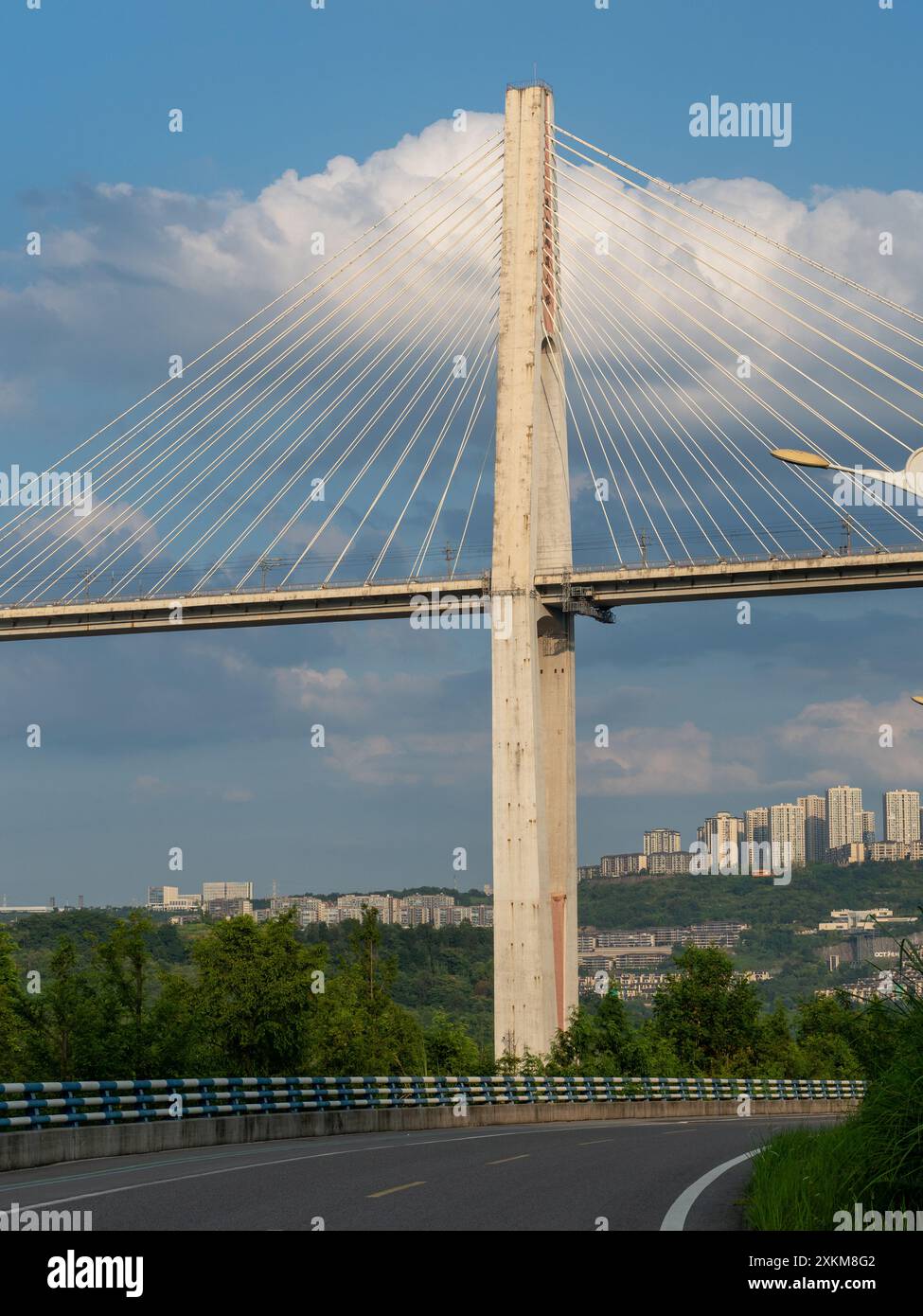 A road alongside Yangtze river, highrise city railway bridge across ...